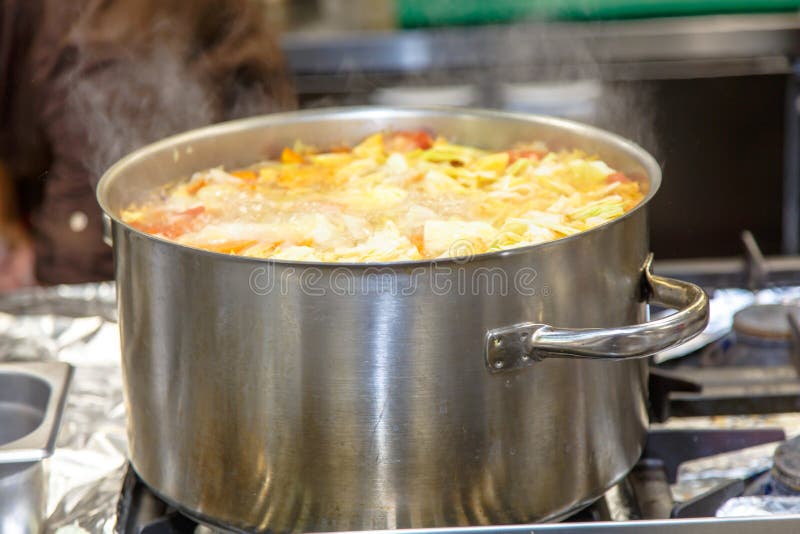 The Soup is Cooked in a Large Pot in the Kitchen in the Restaurant ...