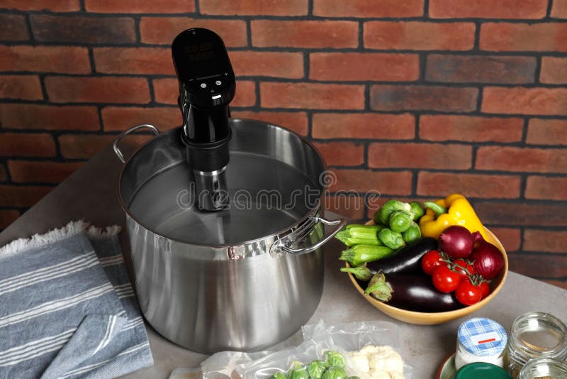 Sous Vide Cooker in Pot and Ingredients on Table. Thermal Immersion ...