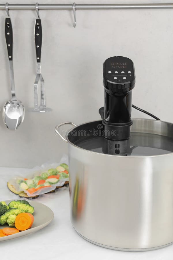 Sous Vide Cooker in Pot and Ingredients on White Table. Thermal ...