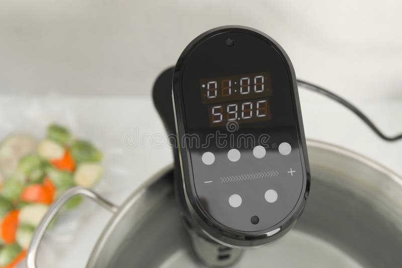 Sous Vide Cooker in Pot on Table, Closeup. Thermal Immersion Circulator ...