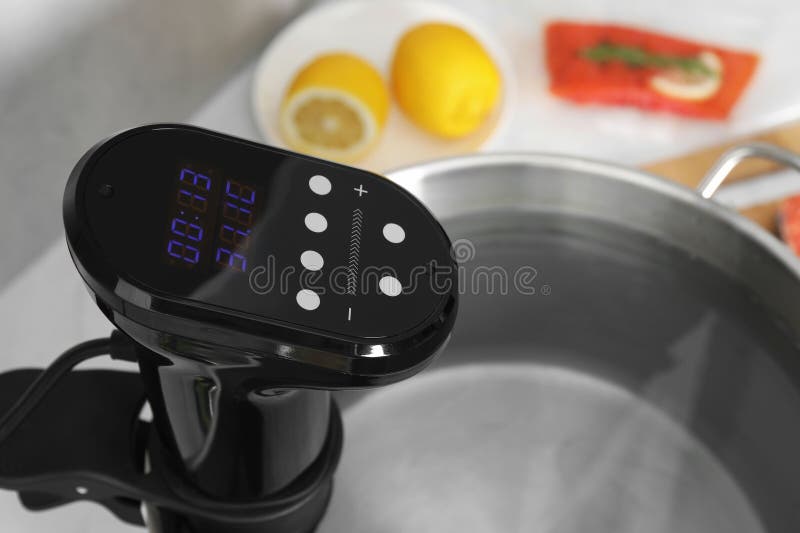 Sous Vide Cooker in Pot on White Table, Closeup. Thermal Immersion ...