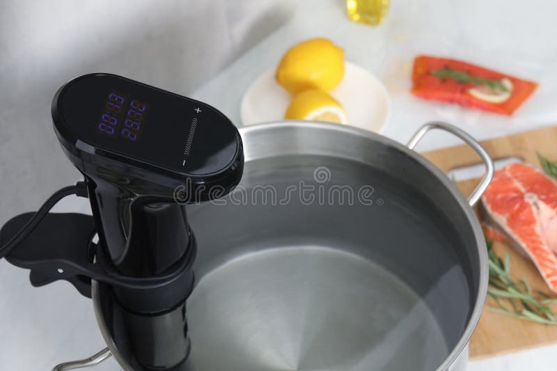 Sous Vide Cooker in Pot on White Table, Closeup. Thermal Immersion ...