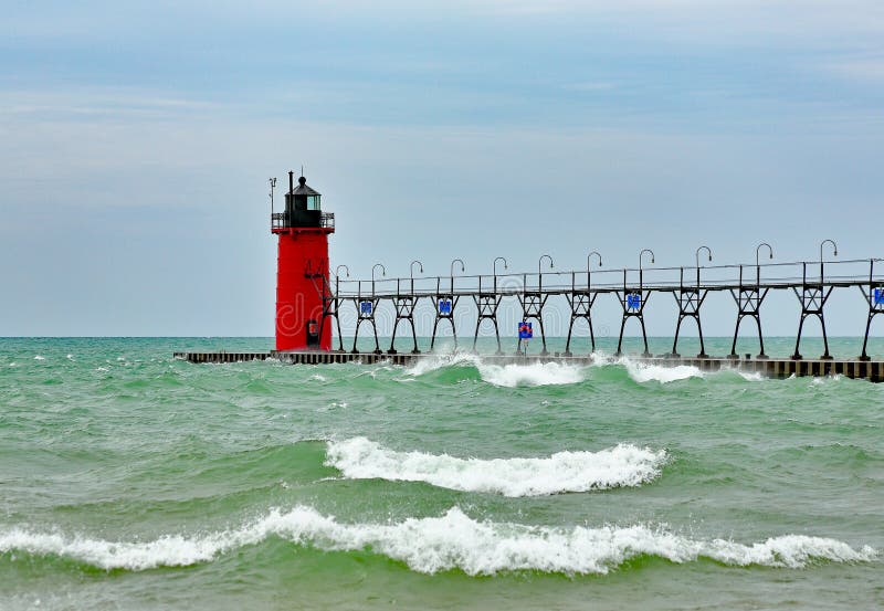 Red Lighthouse on a Windy Day with Waves and Spray Stock Photo - Image ...