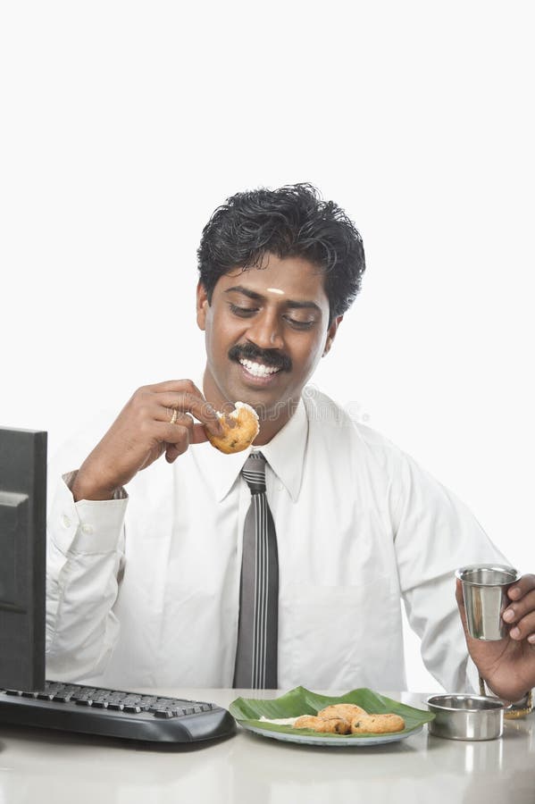 South Indian Businessman Working in an Office and Having Food Stock ...