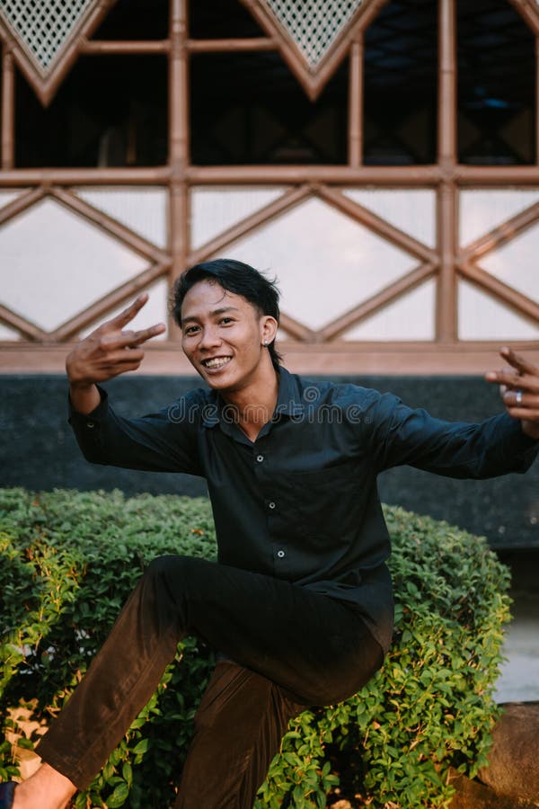 A Southeast Asian Man Striking a Silly Pose with a Playful Expression ...