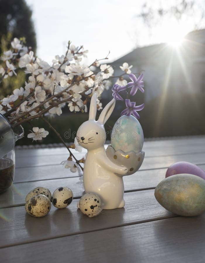 Souvenir Porcelain Easter Bunny Stands on the Table in the Rays of the ...