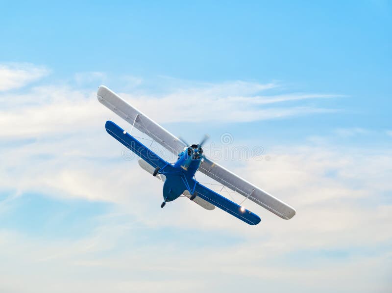 A Soviet Antonov an-2 Single-engine Biplane Flying Against Blue Sky ...