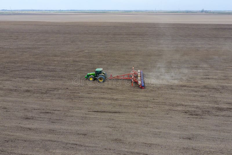 Sowing of Corn. Tractor with a Seeder on the Field Stock Image - Image ...