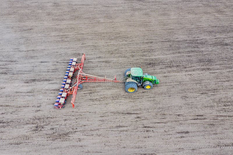 Sowing of Corn. Tractor with a Seeder on the Field. Using a Seeder for ...