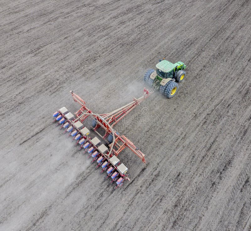 Sowing of Corn. Tractor with a Seeder on the Field. Using a Seeder for ...
