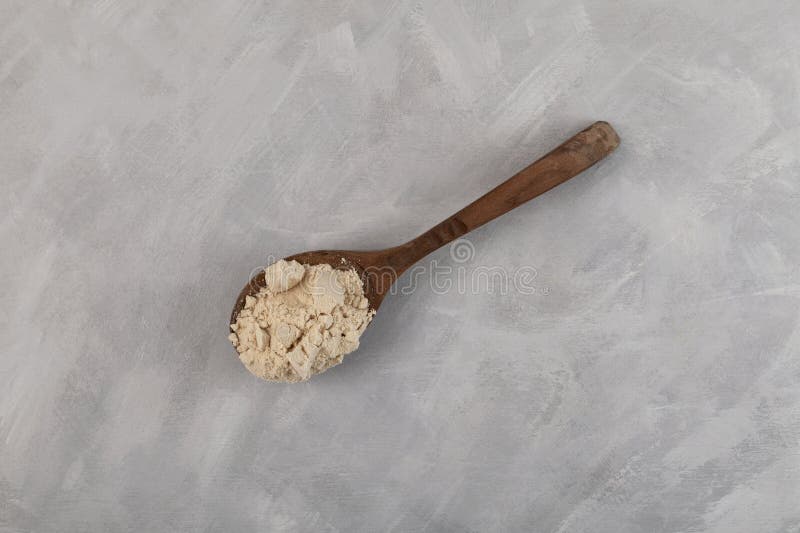 Soy Protein Isolate in Wooden Spoon on Grey Background, Top View. Soy ...