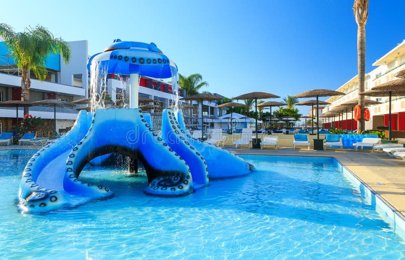 Space by Pool with Sun Loungers and Childrens Playground with Slides ...