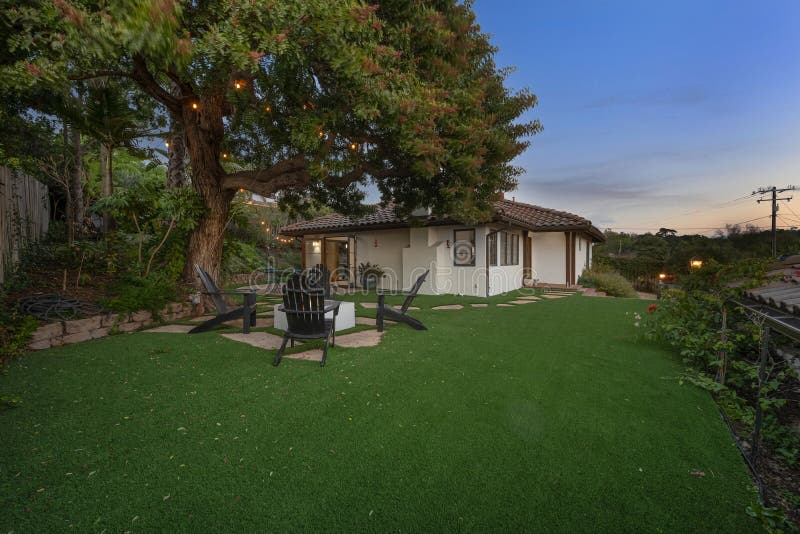 Spacious Backyard with a Green Lawn and Sitting Area Stock Photo ...