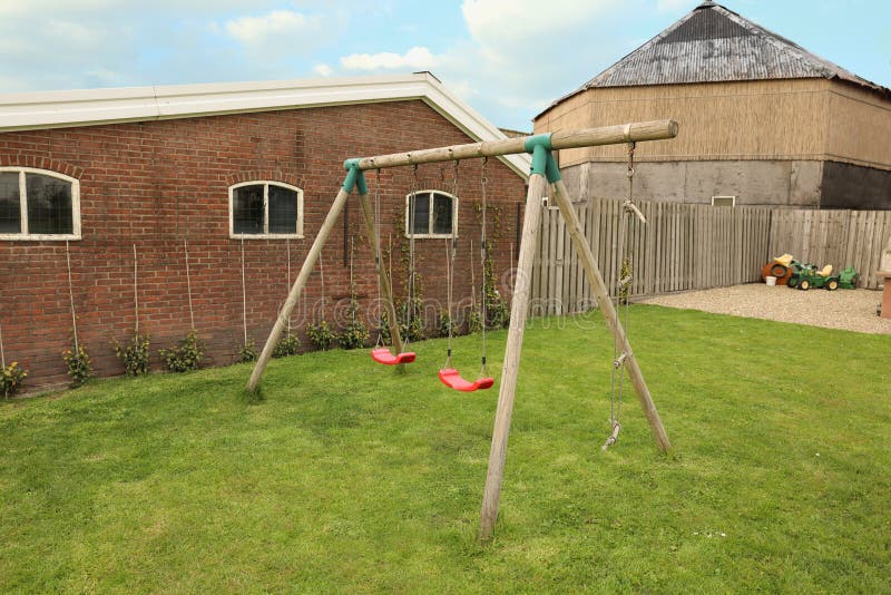 Spacious Backyard with Swing Set on Spring Day Stock Photo - Image of ...