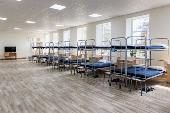 Spacious Dormitory Room with Bunk Beds and Large Windows in Daylight ...