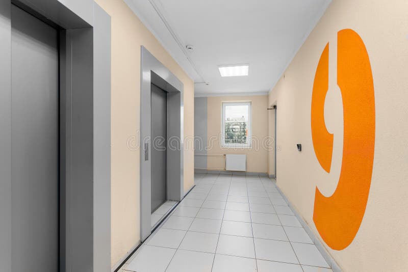 A Spacious Hall with Elevators, a Window at the End of the Corridor ...