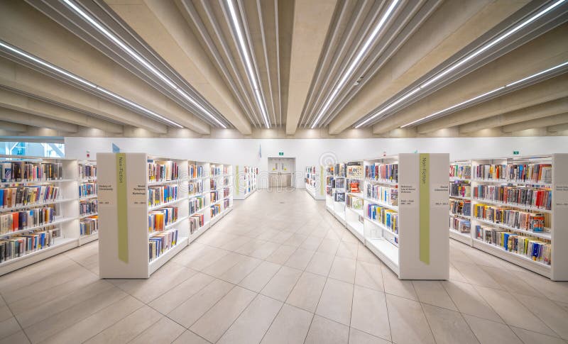 A Spacious Library with Rows of Bookshelves, Bright Lighting, and a ...