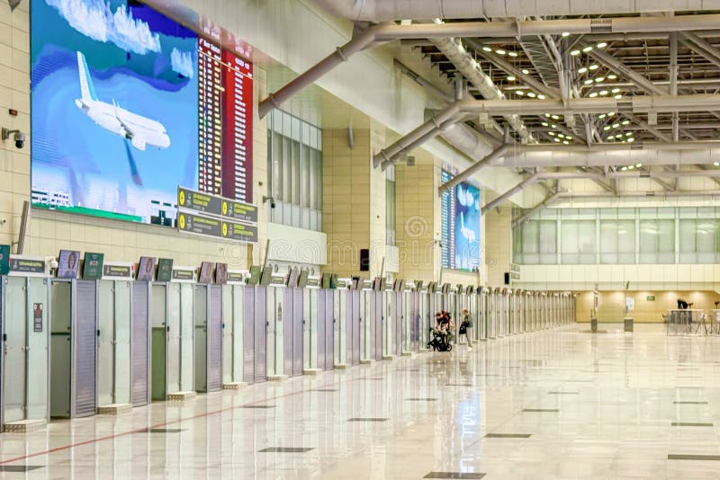 Spacious and Modern Airport Check-in Area Featuring Rows of Counters ...
