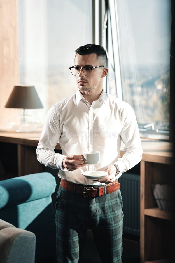 Stylish Young Ceo Standing in His Spacious Light Office Drinking Coffee ...
