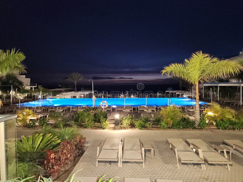 Spacious Pool Surrounded by Palms and Lit Lamps at Night Stock Image ...