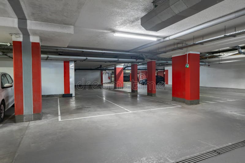 Spacious Underground Parking Garage with Red Columns Stock Image ...