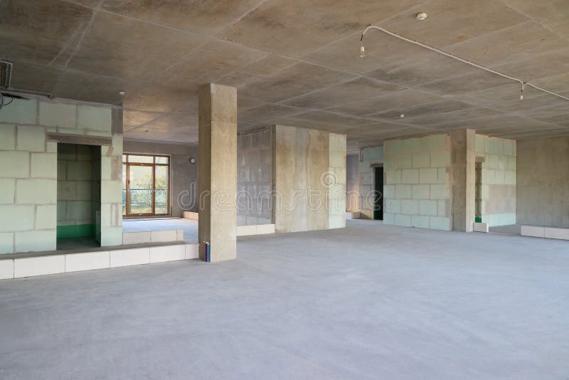 This Spacious Unfinished Interior Has Concrete Walls and an Open Layout ...