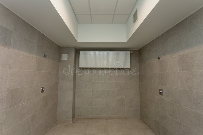 A Spacious and Vacant Concrete Room, Featuring a Skylight Above and ...