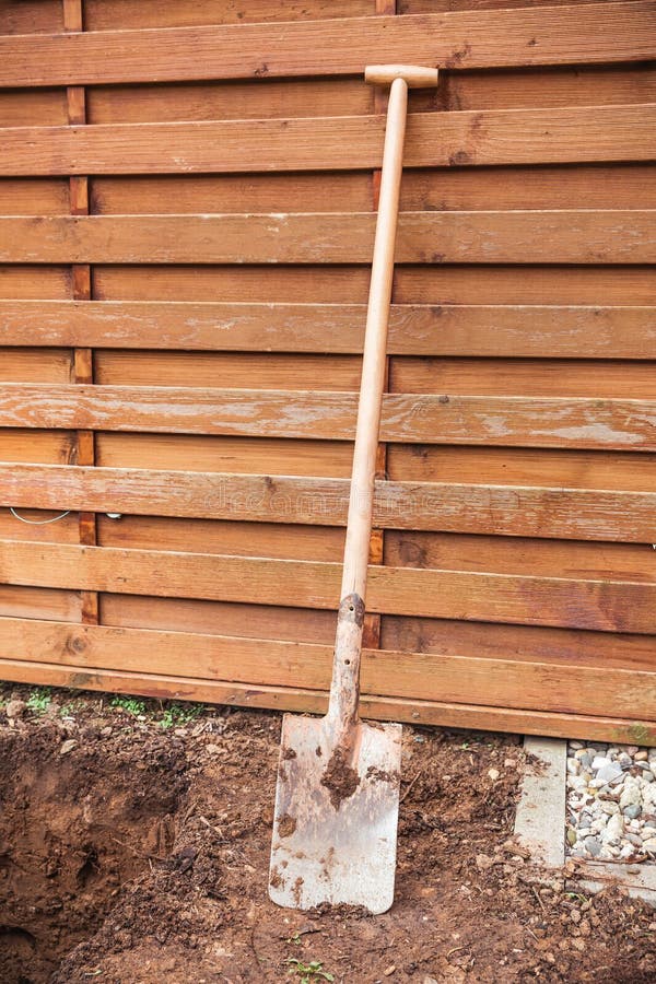 Spade in a Garden with Soil and Wooden Garden Fence Stock Image - Image ...