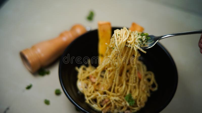 A Bowl of Pasta with a Fork Taking a Bite Out of it Stock Image - Image ...