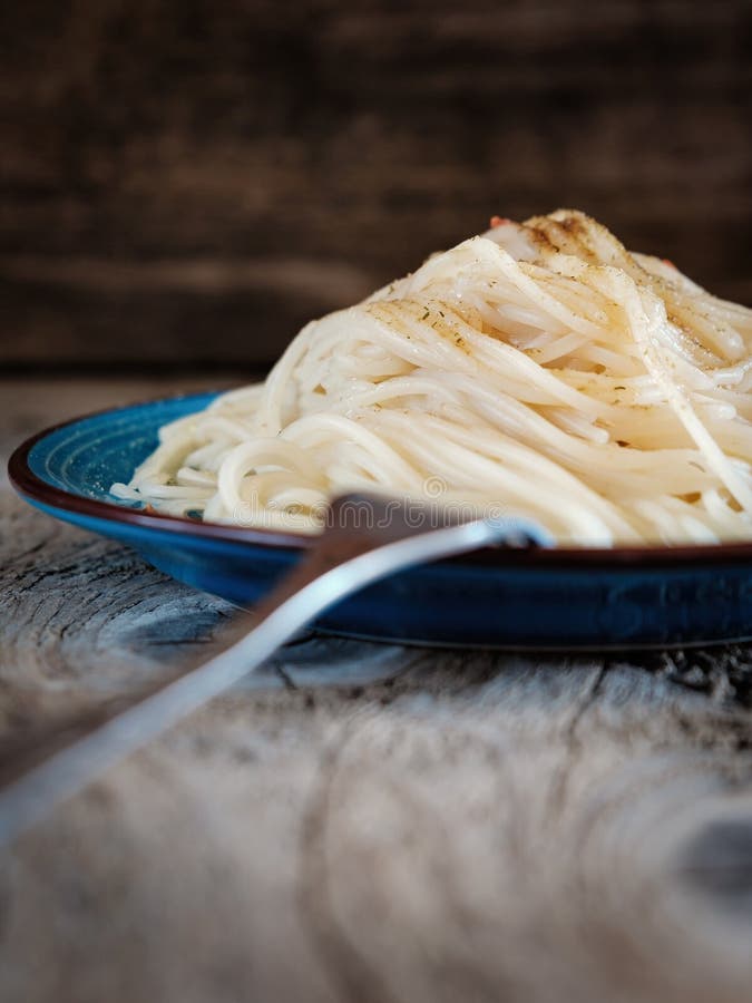 Spaghetti on a blue plate stock photo. Image of brown - 72916054