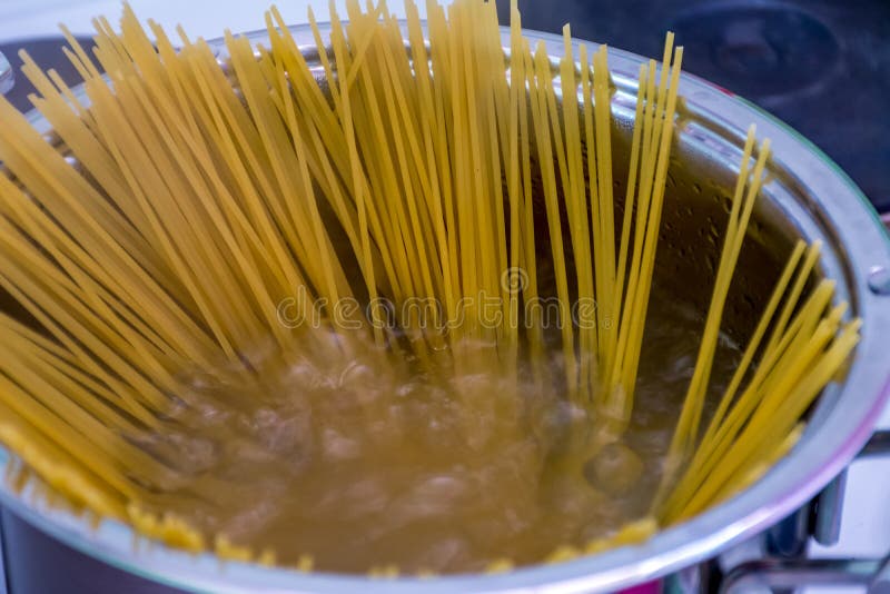 Spaghetti in boiled water stock image. Image of boiling - 100983021