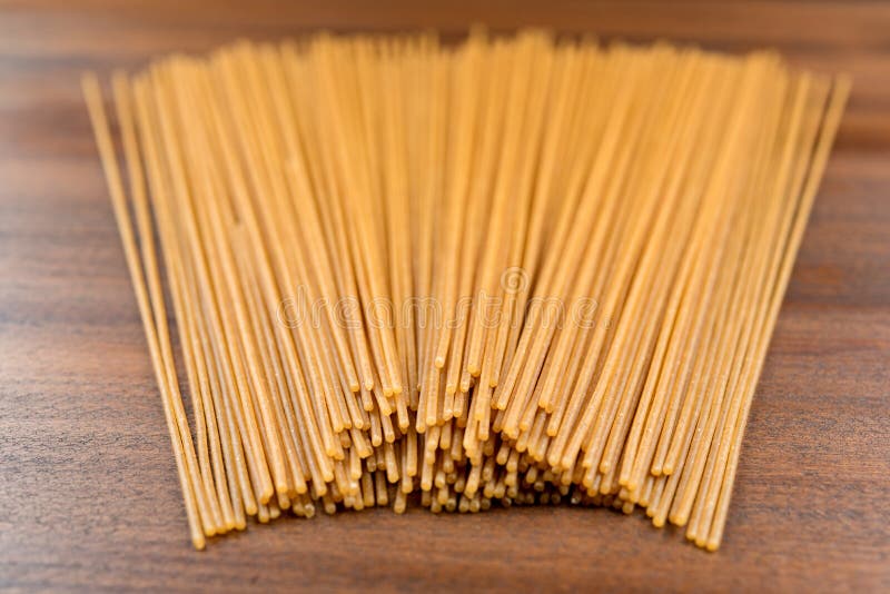 Spaghetti on brown table stock photo. Image of carbohydrate - 60172018