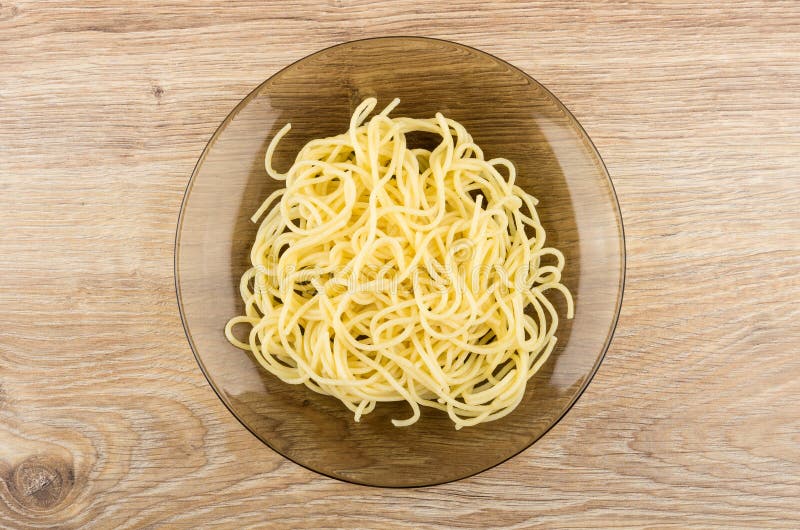 Spaghetti in Brown Transparent Plate on Wooden Table Stock Image ...