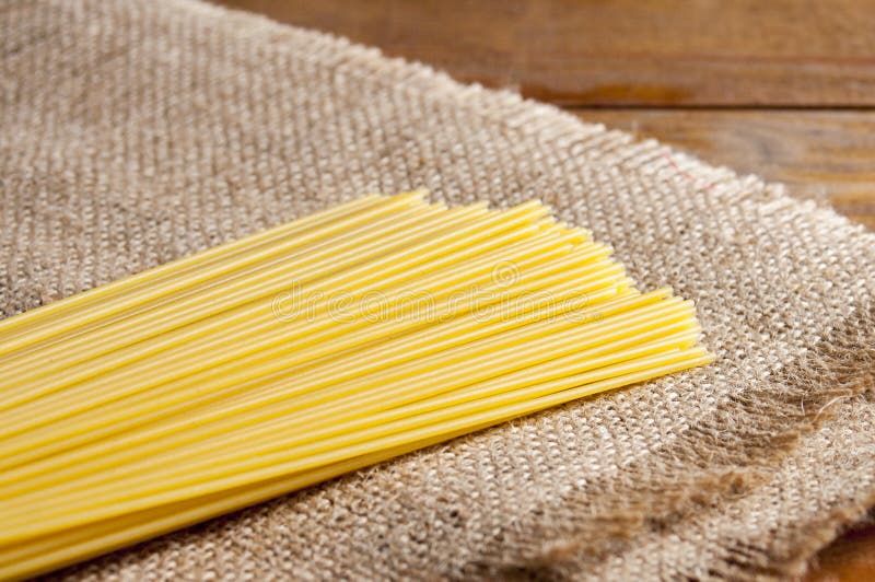 Spaghetti on Burlap on a Brown Wooden Table.Background Stock Photo ...