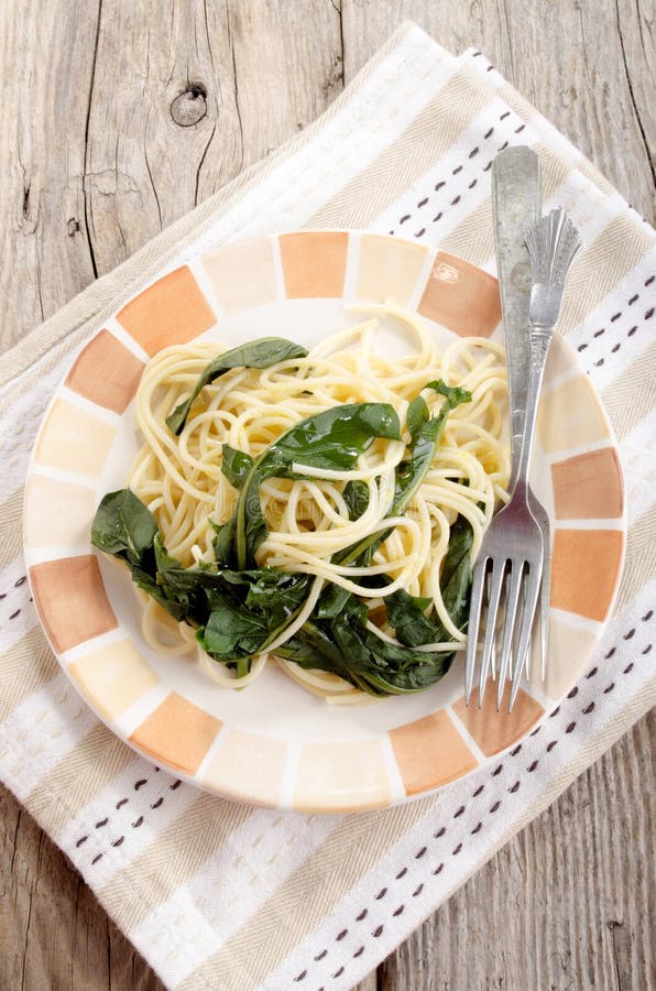Spaghetti with Dandelion Stem on Plate Stock Image - Image of pasta ...