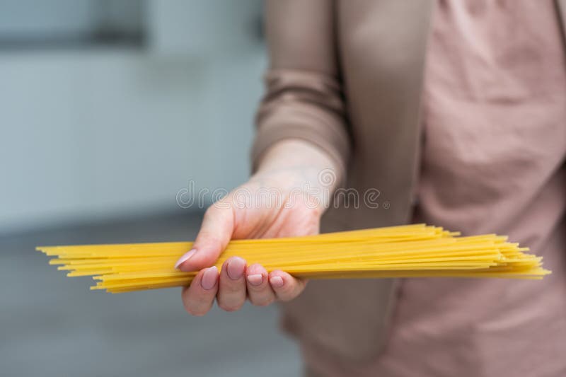 Spaghetti in hand on white stock image. Image of culinary - 309138761