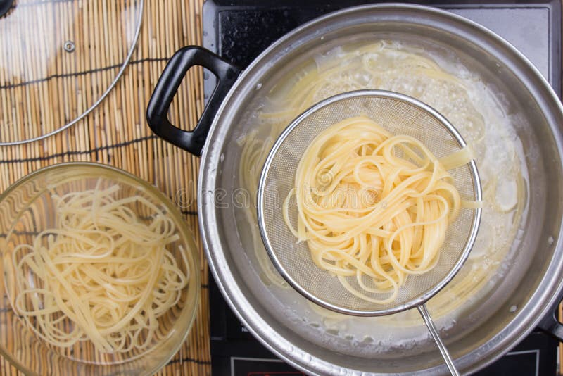 Spaghetti Lifted on of Cold Water with Colander Stock Photo - Image of ...