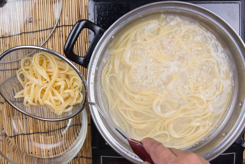 Spaghetti Lifted on of Cold Water with Colander Stock Photo - Image of ...