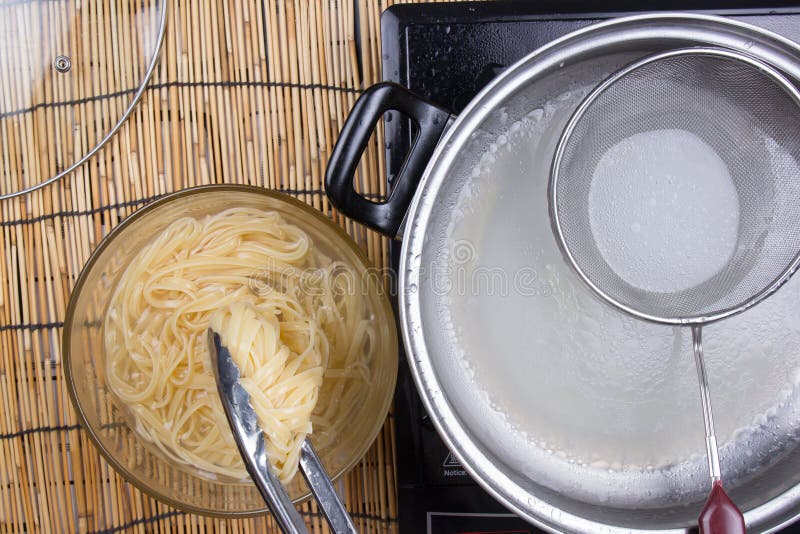 Spaghetti Lifted on of Cold Water with Tongs Stock Photo - Image of ...