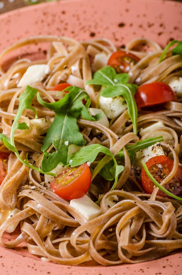 Spaghetti with Mozzarella, Cherry Tomatoes and Arugula Stock Image ...