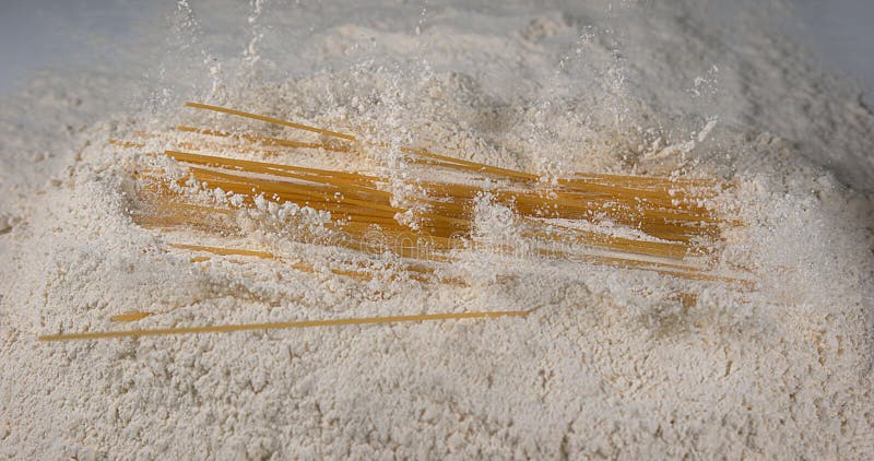 Spaghetti Pasta Falling on Flour Stock Photo - Image of movement ...