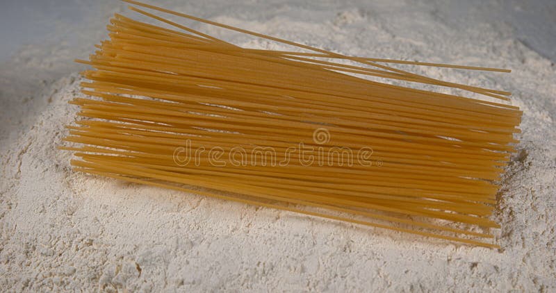 Spaghetti Pasta Falling on Flour Stock Photo - Image of pasta, indoors ...
