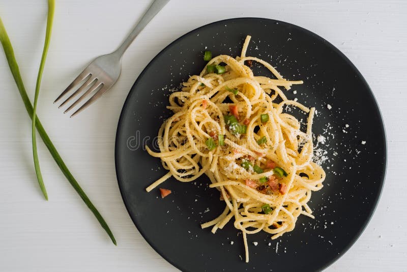 Spaghetti Pasta Sprinkled with Cheese Parmesan and Green Onions on a ...