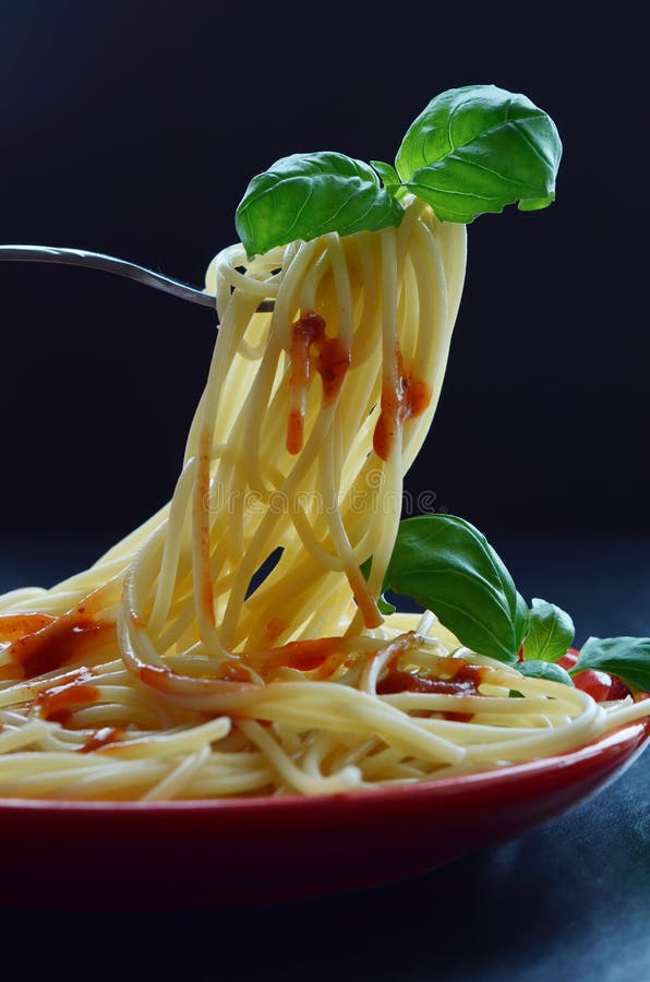 Spaghetti With Basil Garnish And Tomato Sauce. Stock Photo - Image of ...