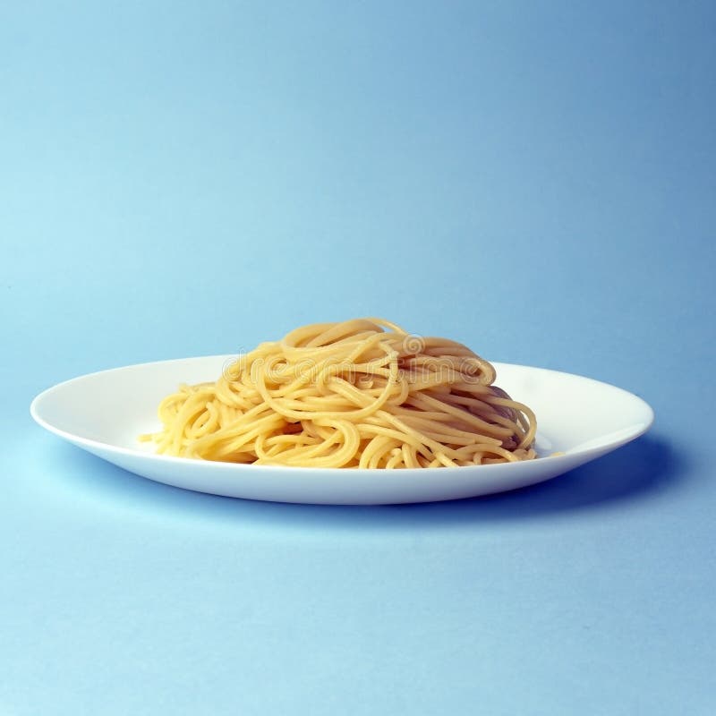 Spaghetti Pasta on a White Plate on a Blue Background. Creative ...
