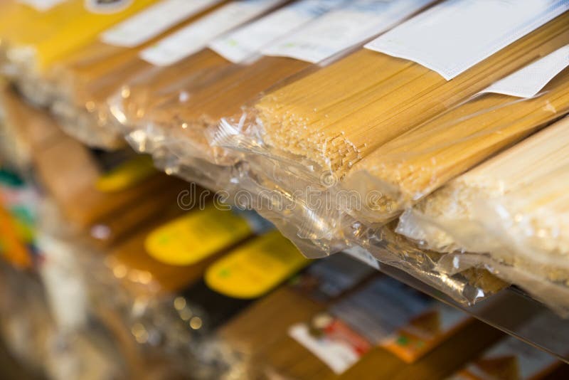 Spaghetti in Plastic Packaging on Shelves Stock Photo - Image of pack ...