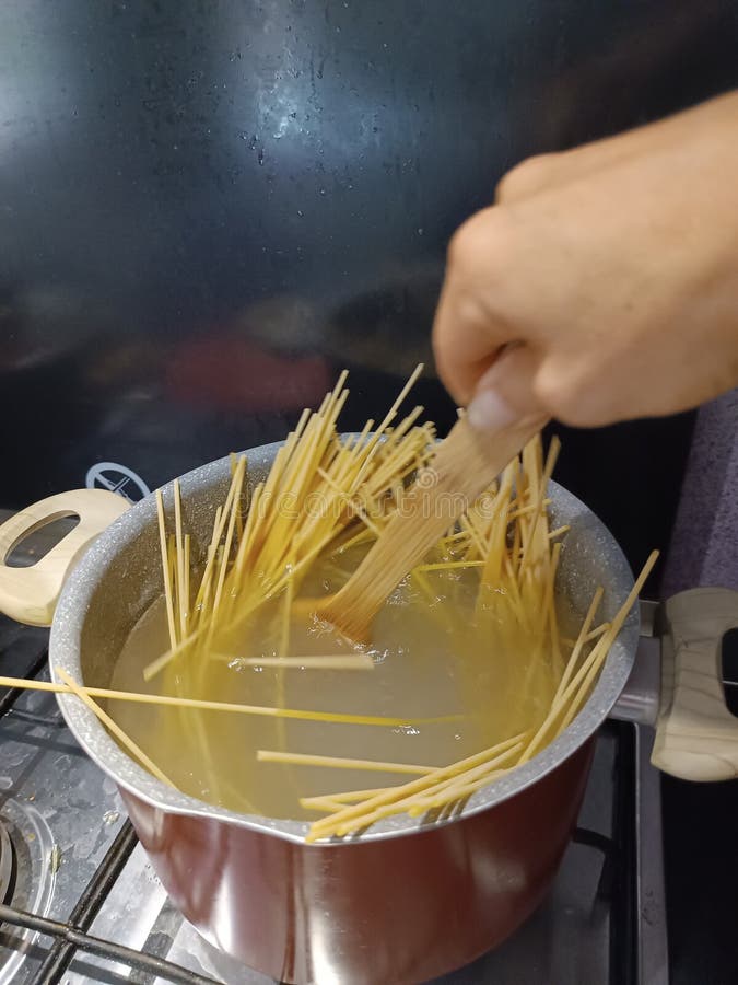 The Spaghetti in the Pot of Boiling Water Must Be Turned Over To ...