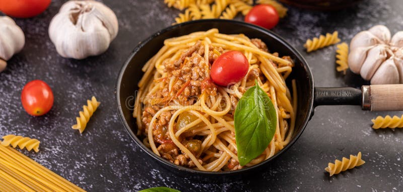 Spaghetti Sauteed in a Pan-fried with Tomatoes and Basil Stock Photo ...