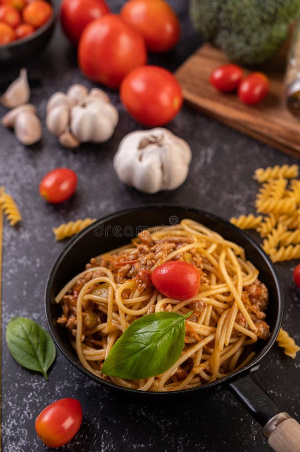 Spaghetti Sauteed in a Pan-fried with Tomatoes and Basil Stock Photo ...