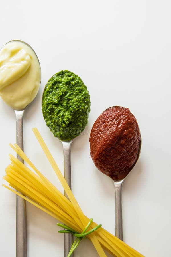 Spaghetti and Three Spoons with Different Condiments Stock Photo ...